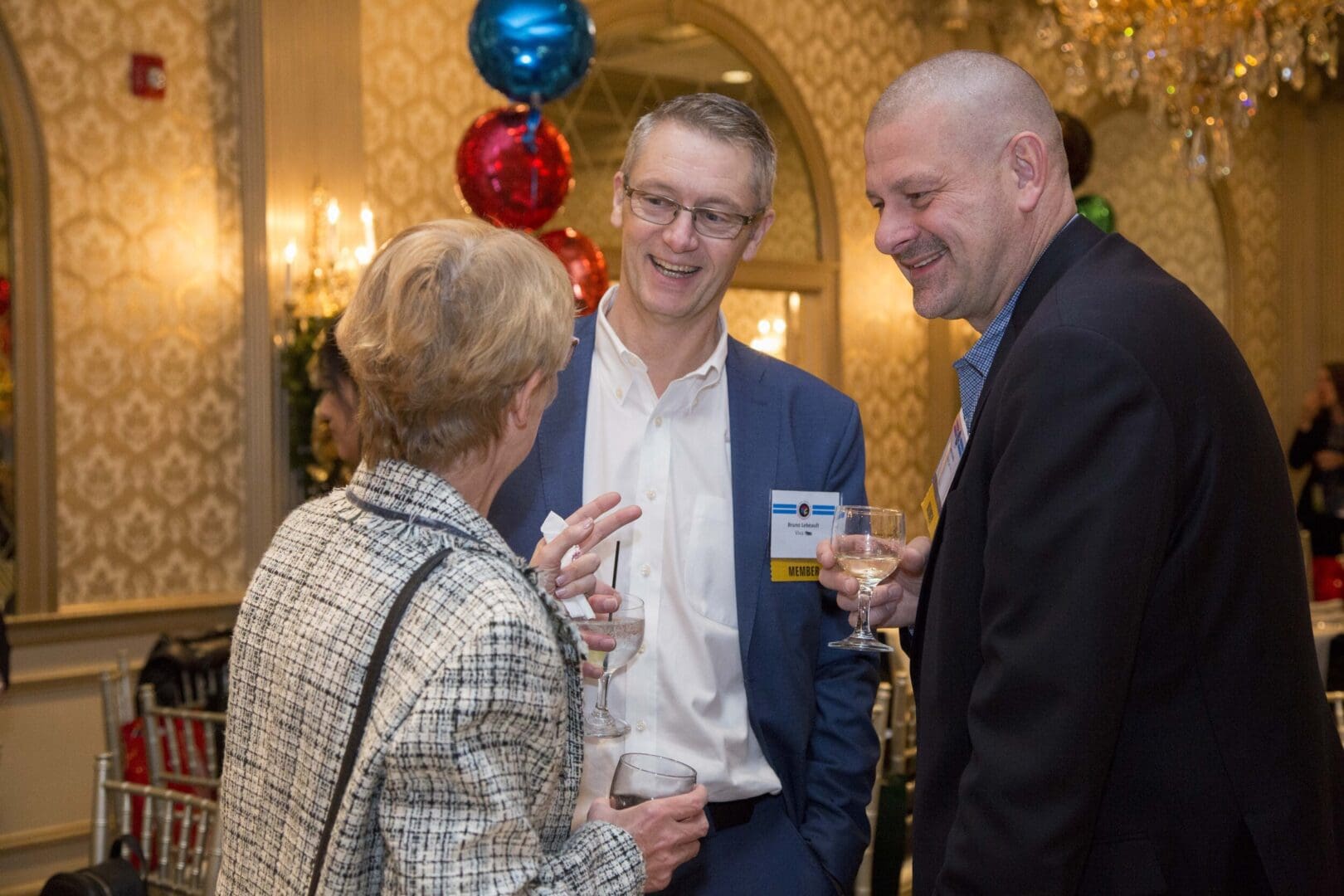 Three people talking to each other at an event. - New Jersey Packaging ...